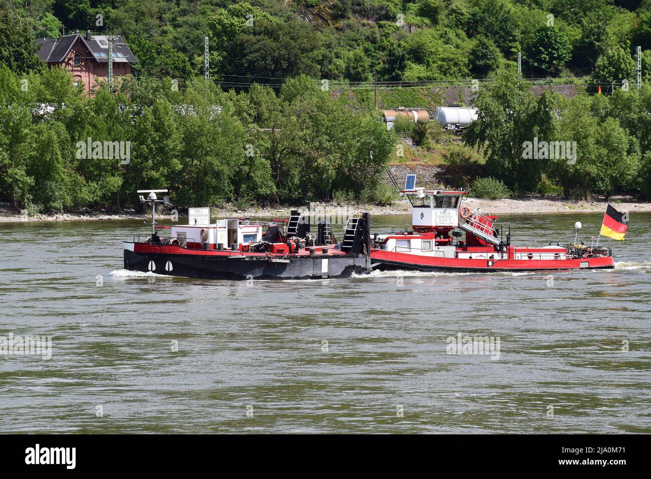 red ship pushing a float Stock Photo - Alamy