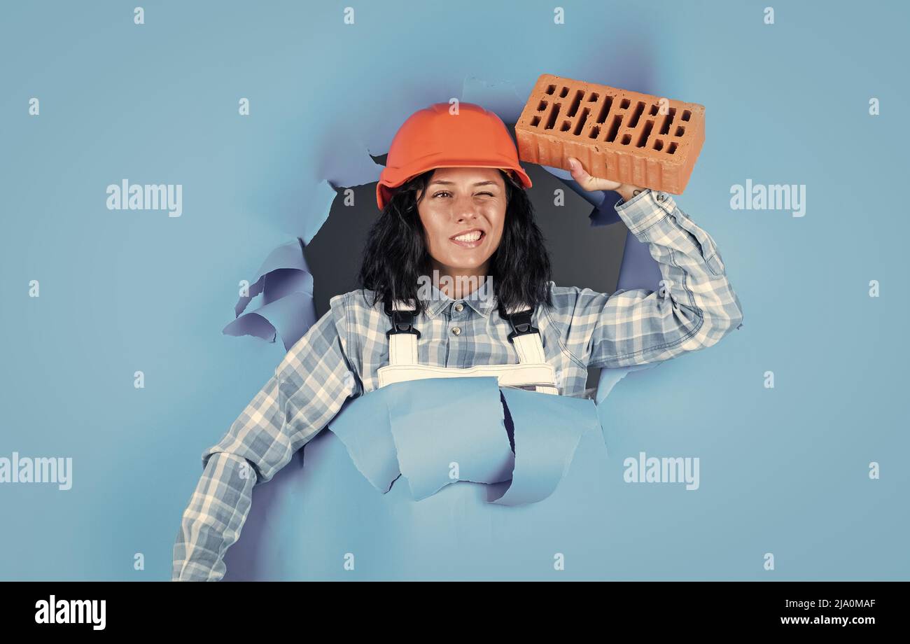 builder assistant wear protective helmet. girl in workshop uniform ...