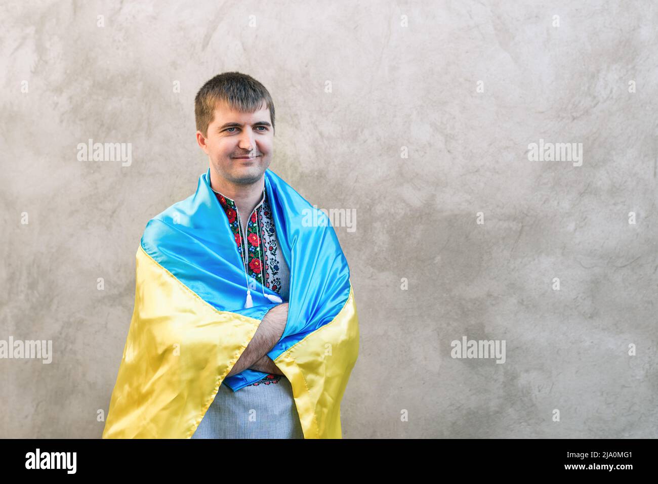 Young smiling Ukrainian with blue and yellow State Flag of Ukraine. Man ...