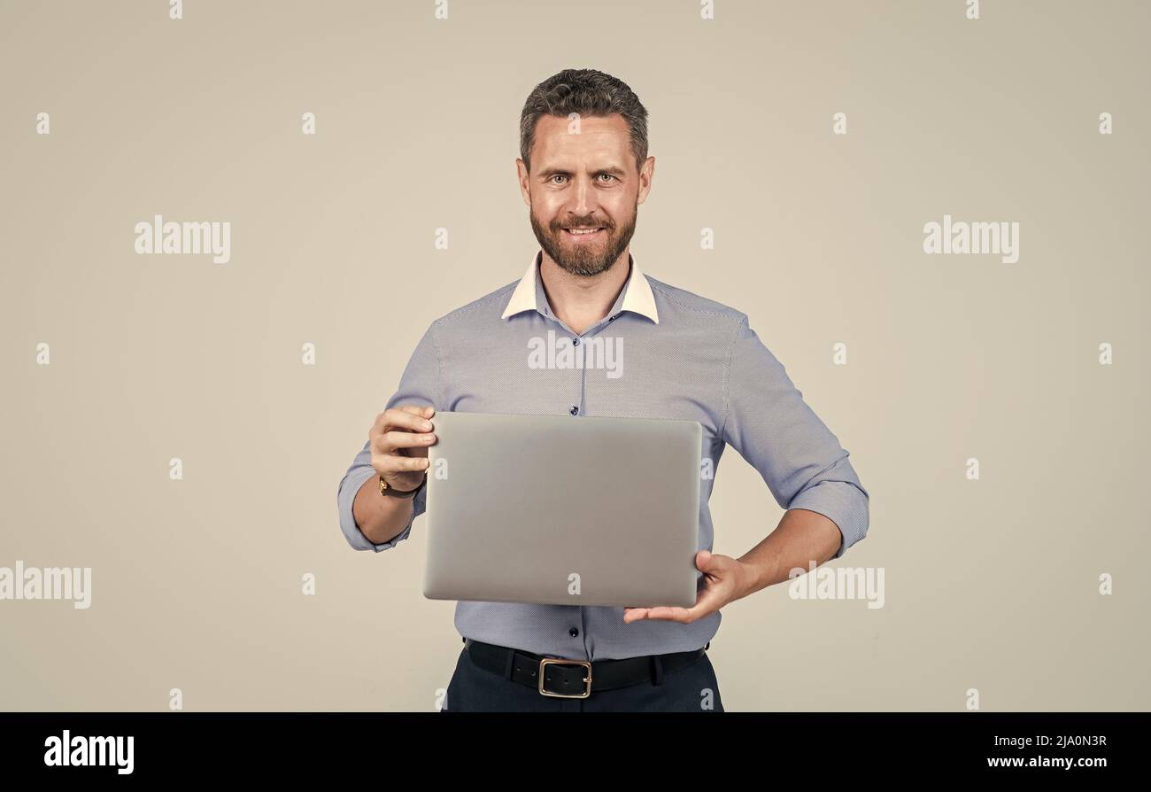 cheerful businessman working online. business success. programmer man presenting pc ...