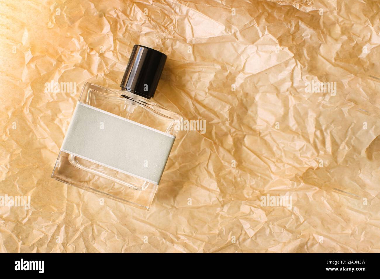 Close-up of glass bottle of perfume on craft paper. Cosmetics and self ...