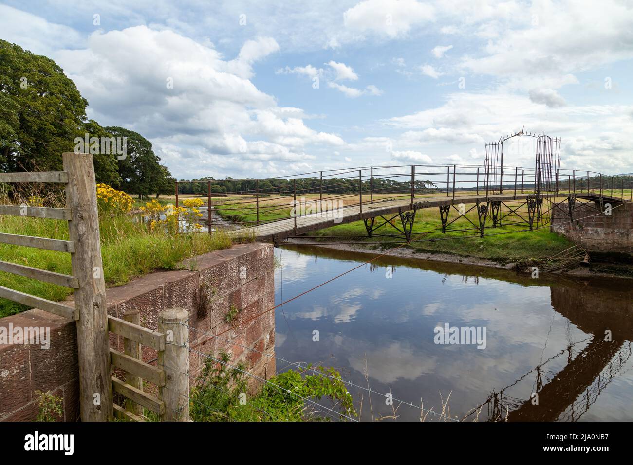 The old footbridge over the River Tyne in Tyninghame Estate, East ...