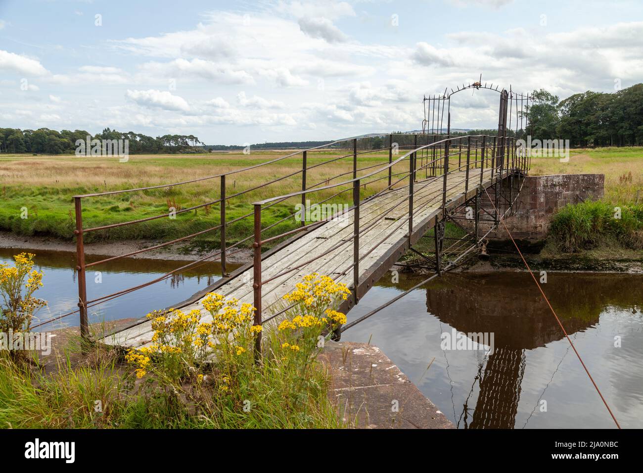 The old footbridge over the River Tyne in Tyninghame Estate, East ...