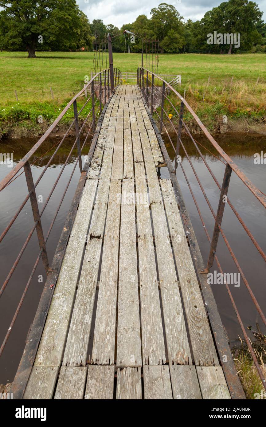 The old footbridge over the River Tyne in Tyninghame Estate, East ...