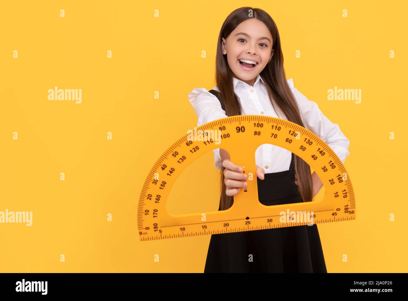 amazed kid in school uniform hold mathematics protractor for measuring ...