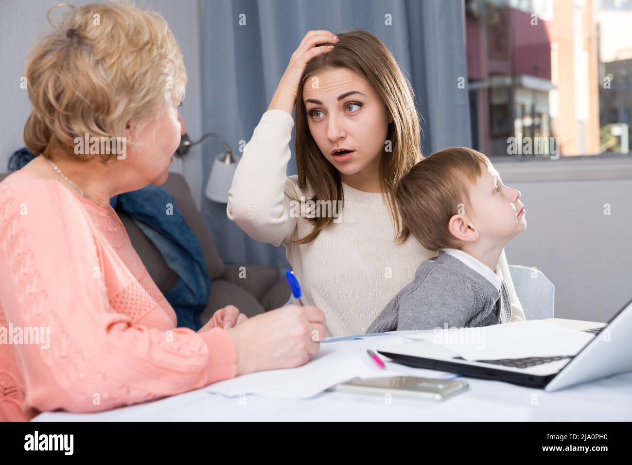 Adult female with her mother are having problems with filling documents ...