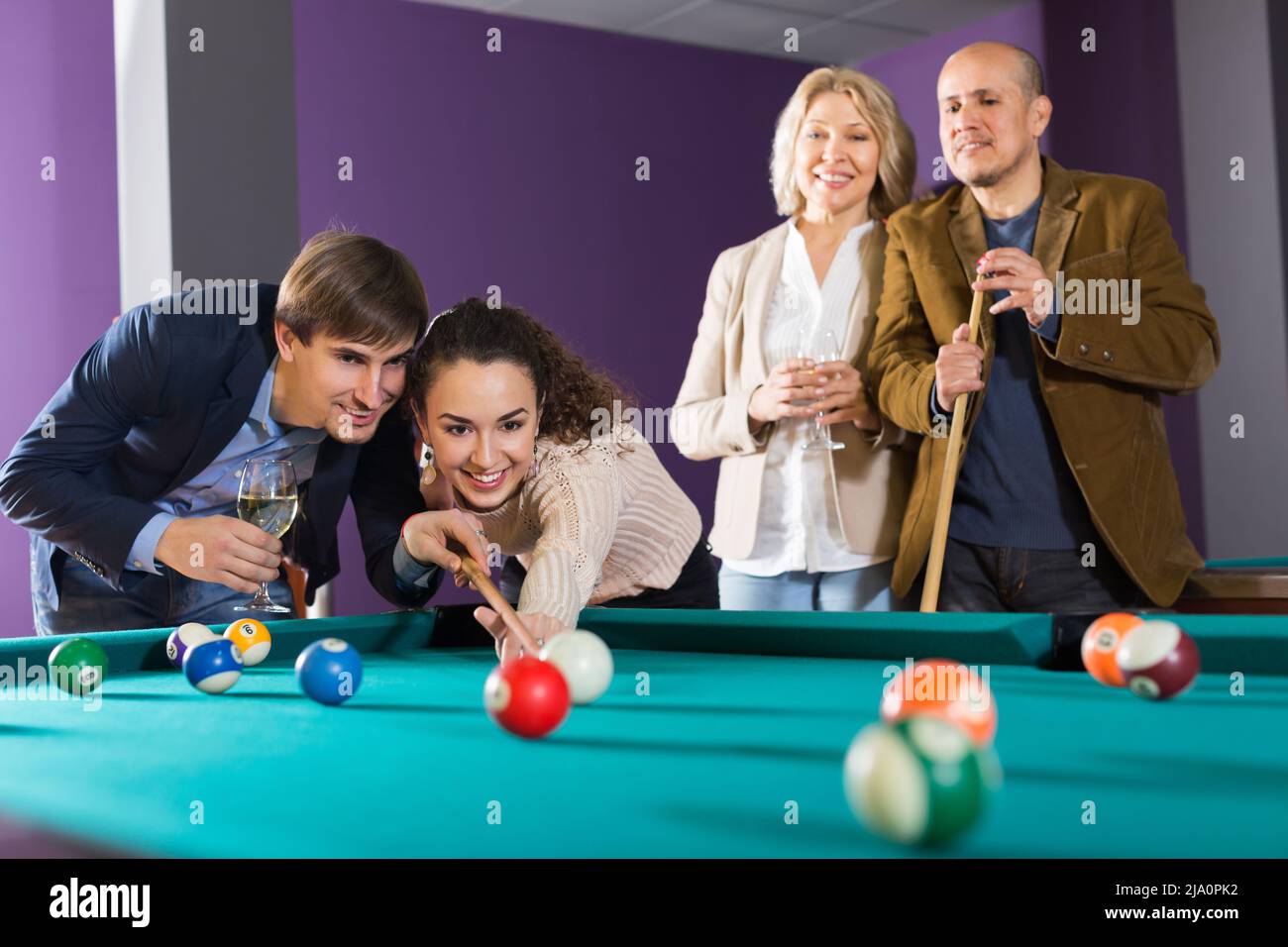 Laughing middle class people having pool game Stock Photo - Alamy