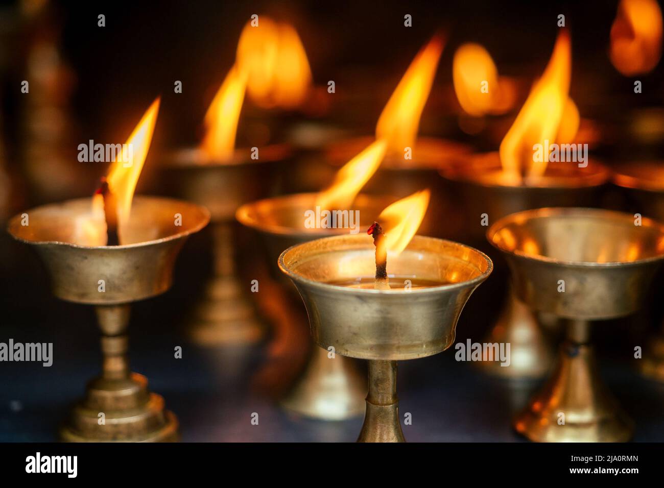 a prayer candle and a flame on a dark background. the concept of ...