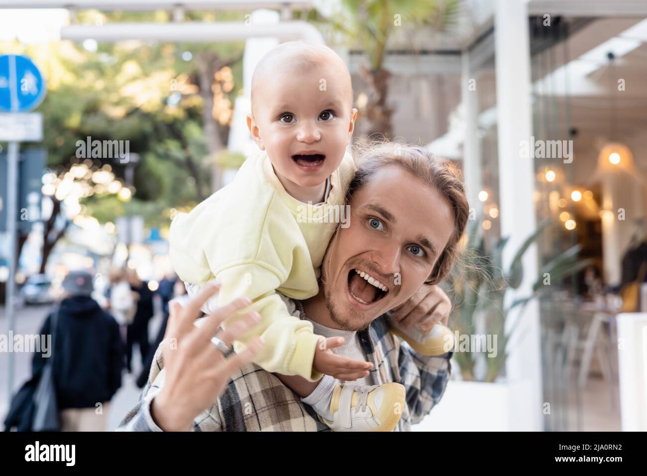 Excited father and child looking away on urban street in Treviso Stock ...