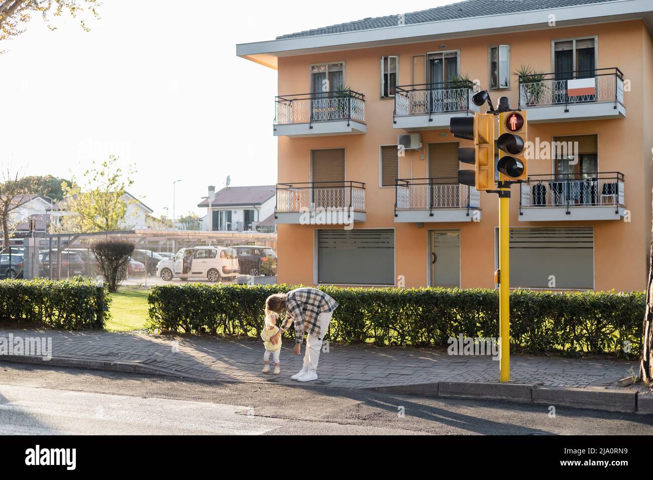 Young dad standing near baby girl and crosswalk on urban street in ...