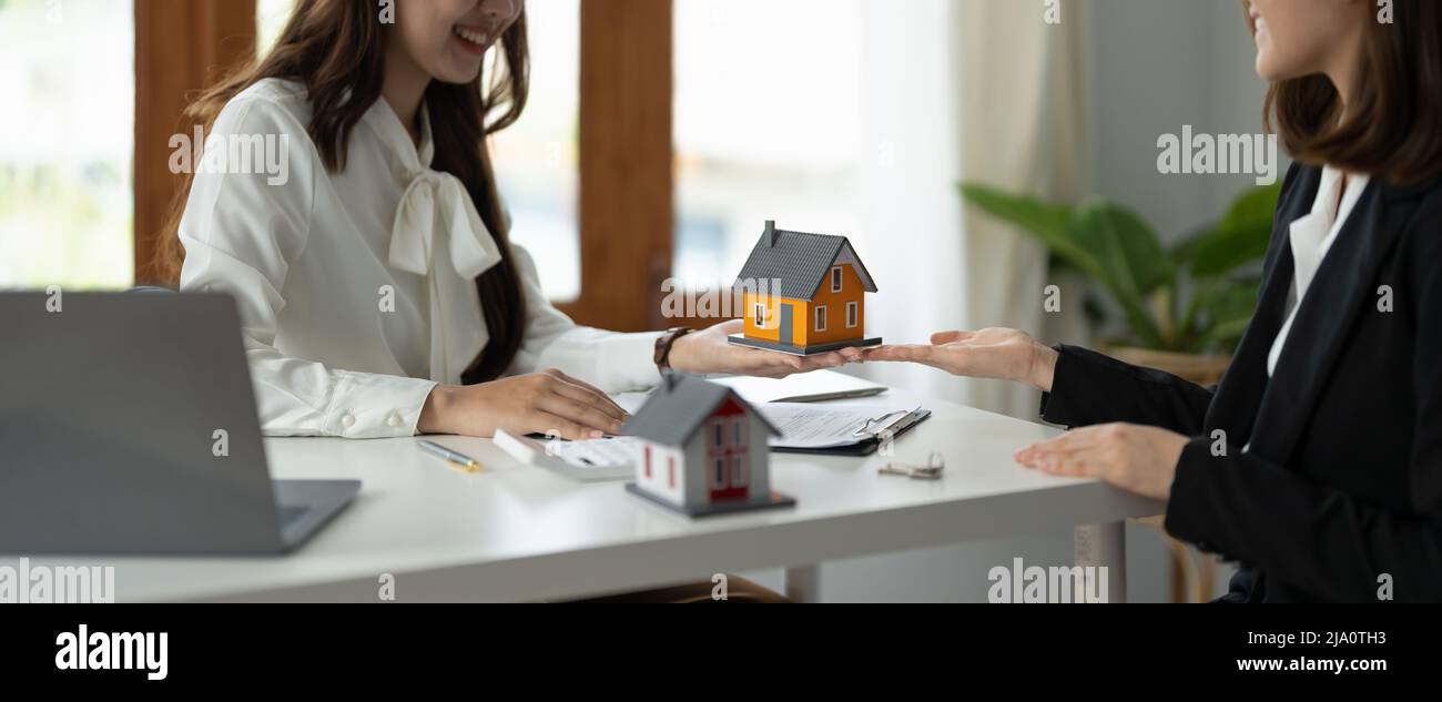 experienced real estate agent showing house model to client and ready ...
