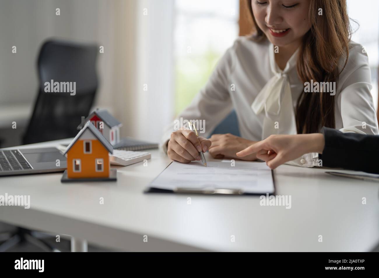 experienced real estate agent showing house model to client and ready ...