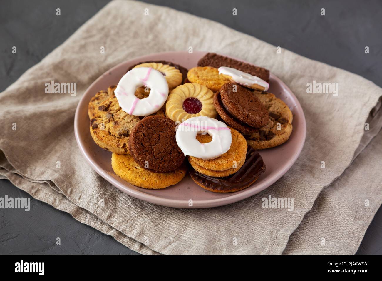 Variety of Biscuits on a pink Plate, side view Stock Photo - Alamy