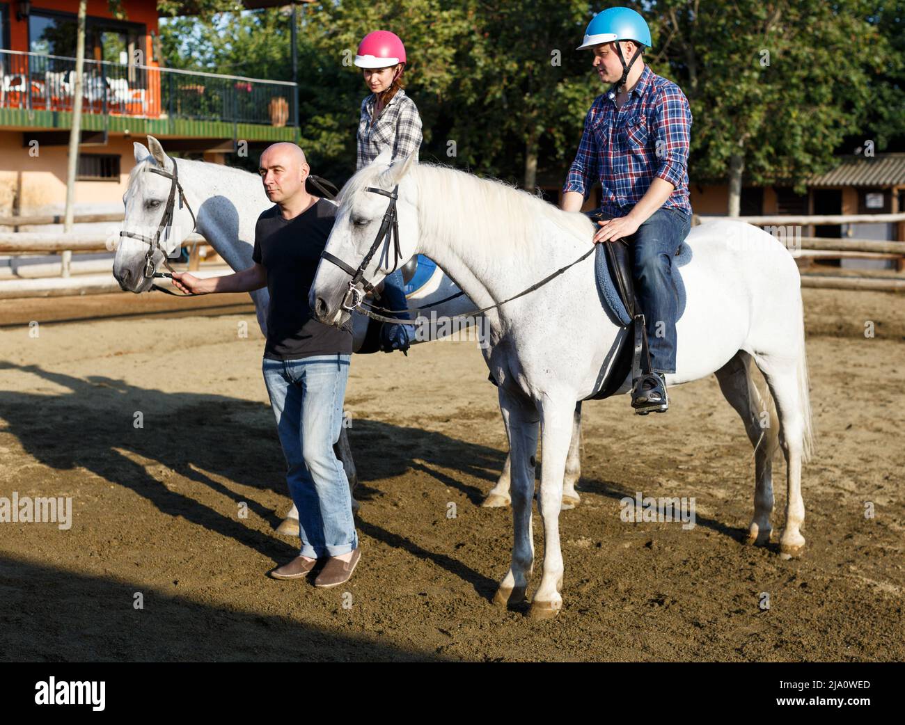 Mature male trainer guiding female hi-res stock photography and images ...