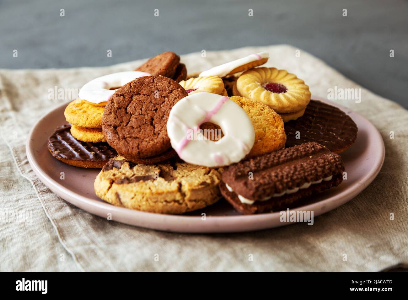 Variety of Biscuits on a pink Plate, side view. Close-up Stock Photo ...