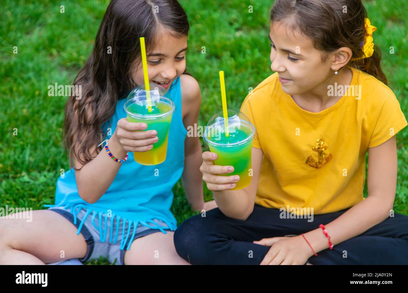 children drink a cocktail in the park. Selective focus Stock Photo - Alamy