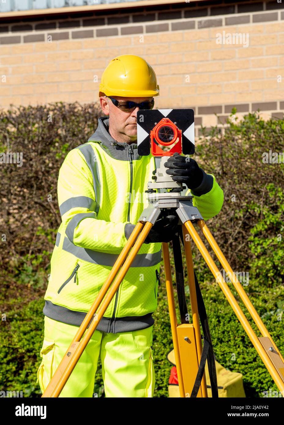 Site engineer installing backsight prism above control points on ...