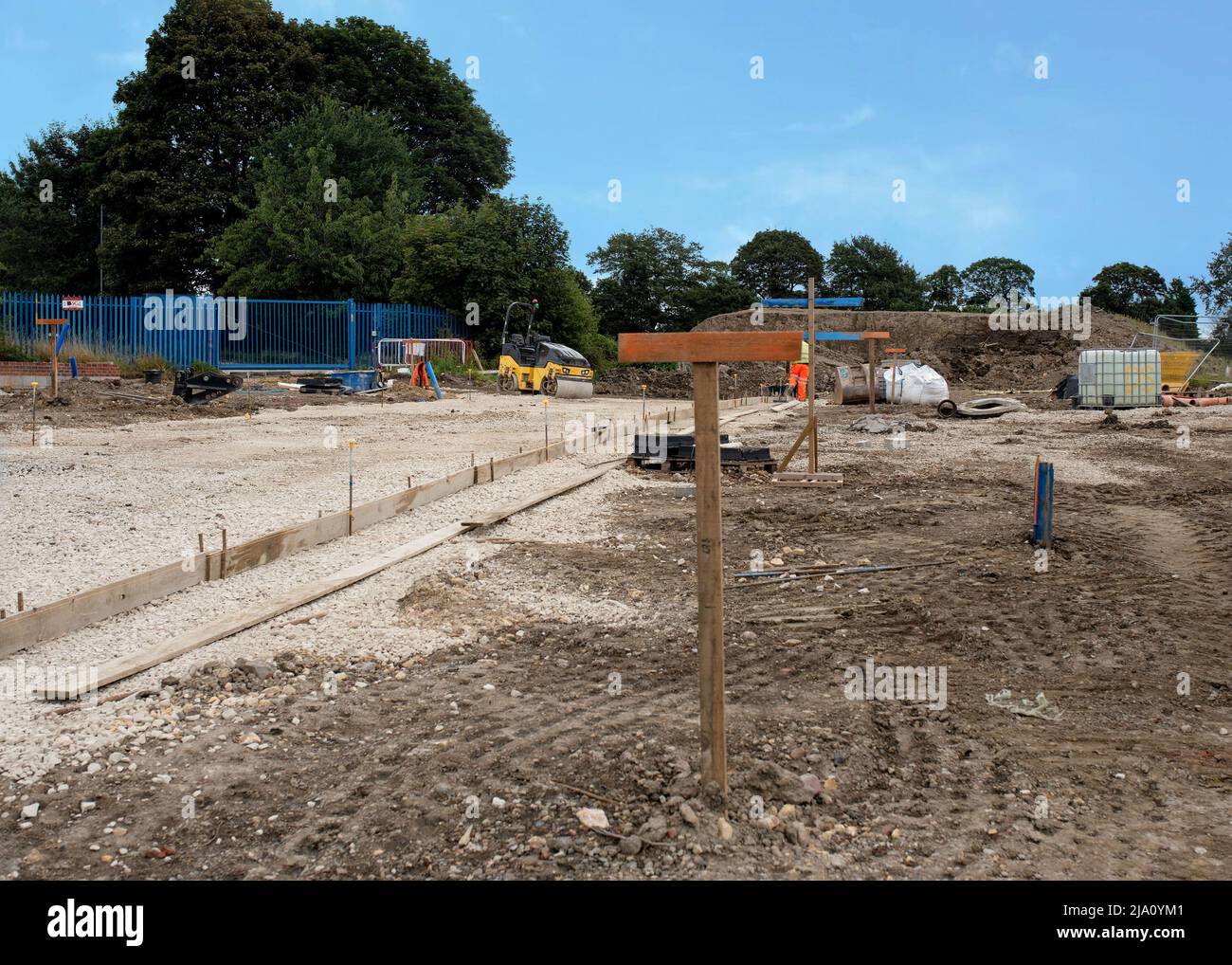 Roller parked next to profiles set by site engineer for levels for new ...