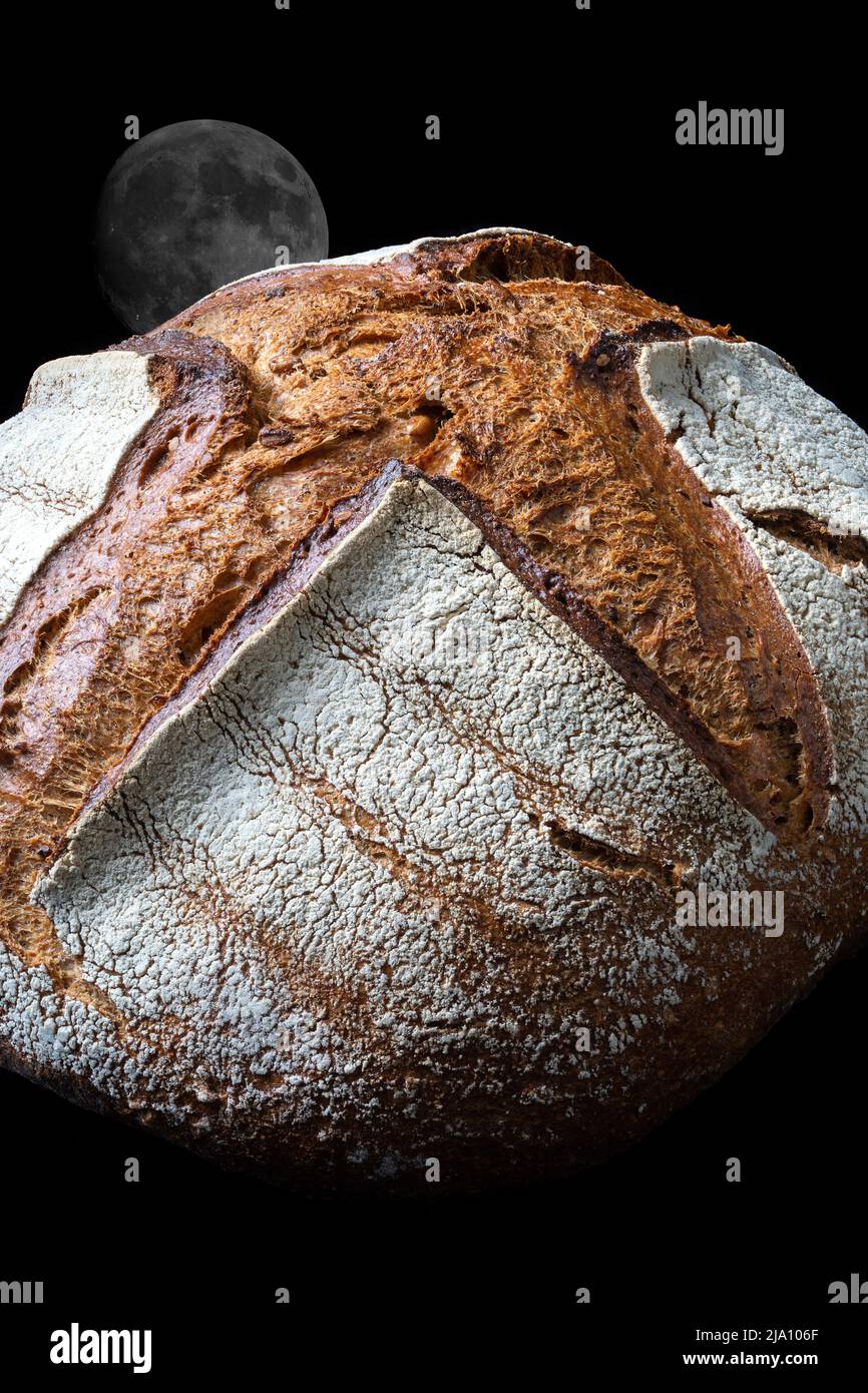 Close up shot of a loaf of bread in the moonlight with a black ...