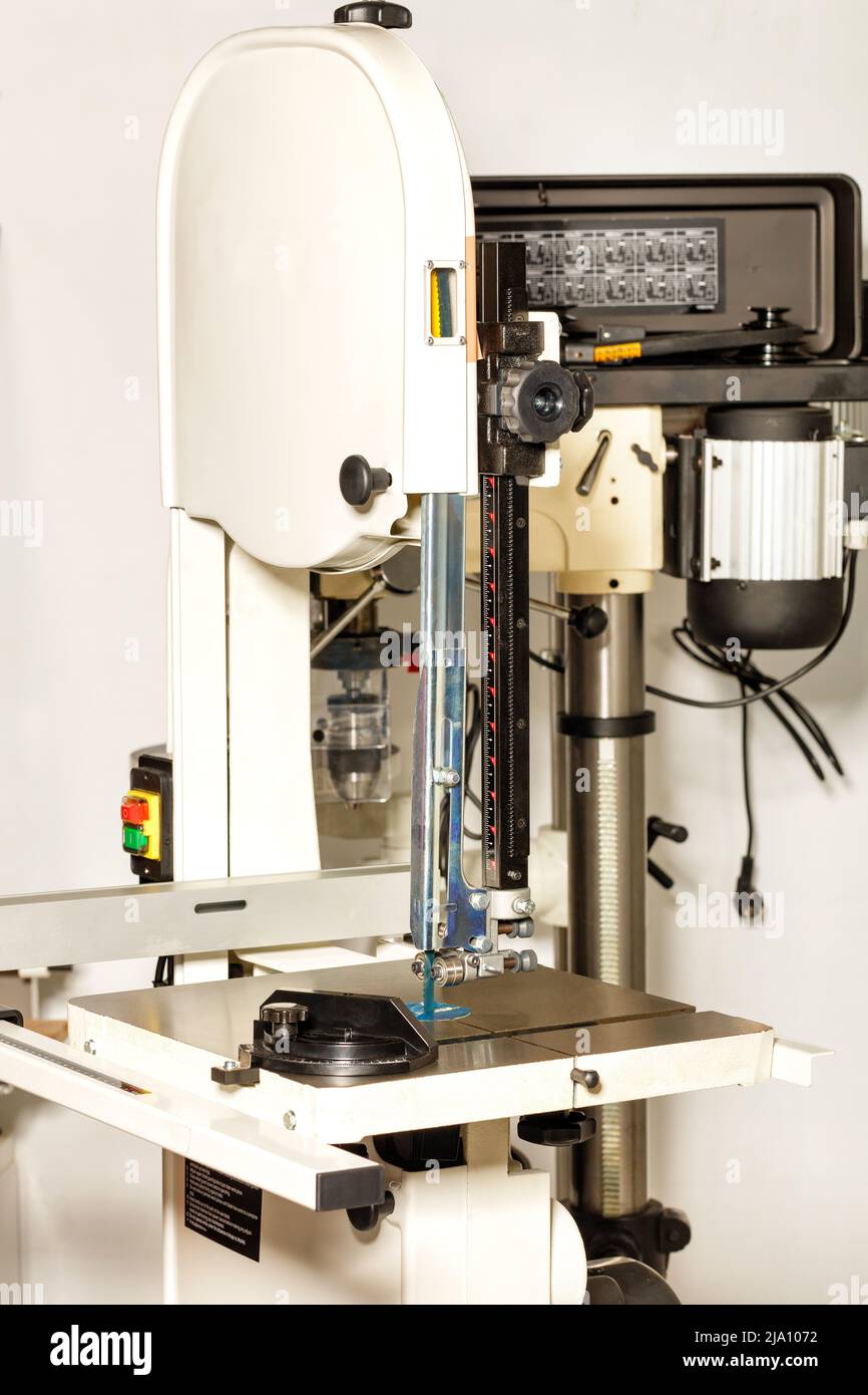 Industrial band saw with powerful motor and metal base for precise ...