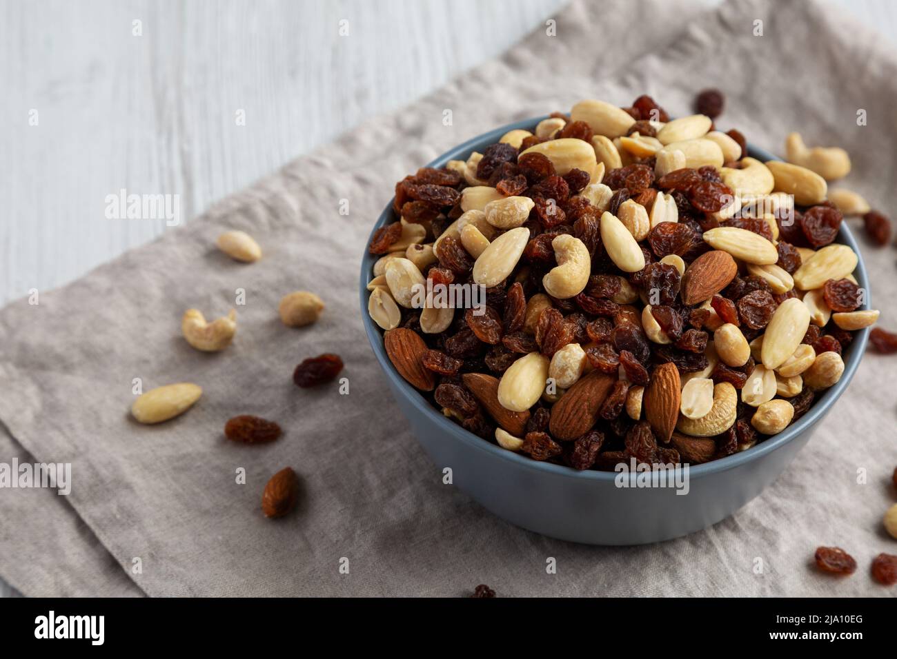 Raw Trail Mix with Nuts and Fruits in a Bowl, side view. Space for text ...