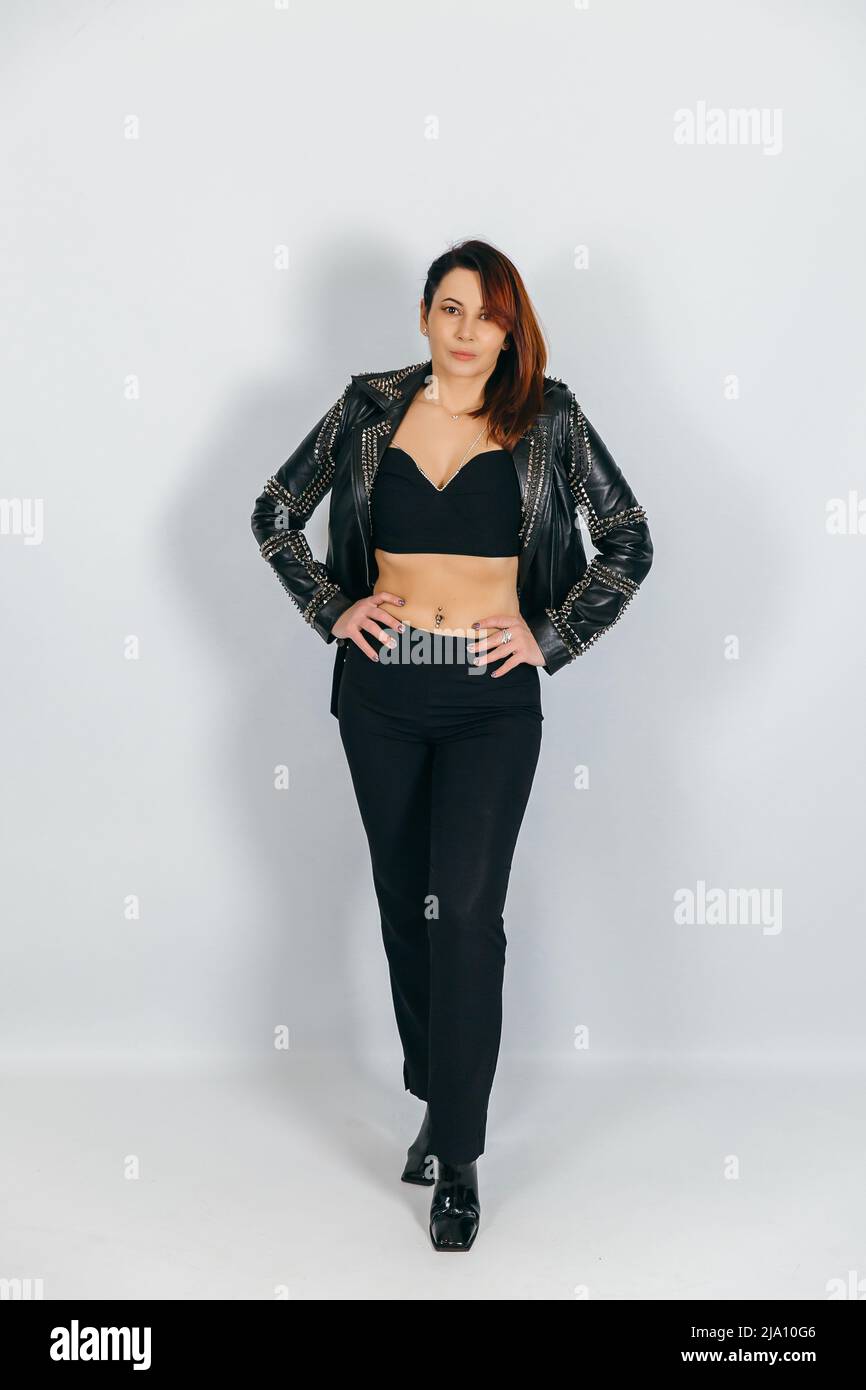 beautiful woman model in studio in black jacket and pants Stock Photo ...