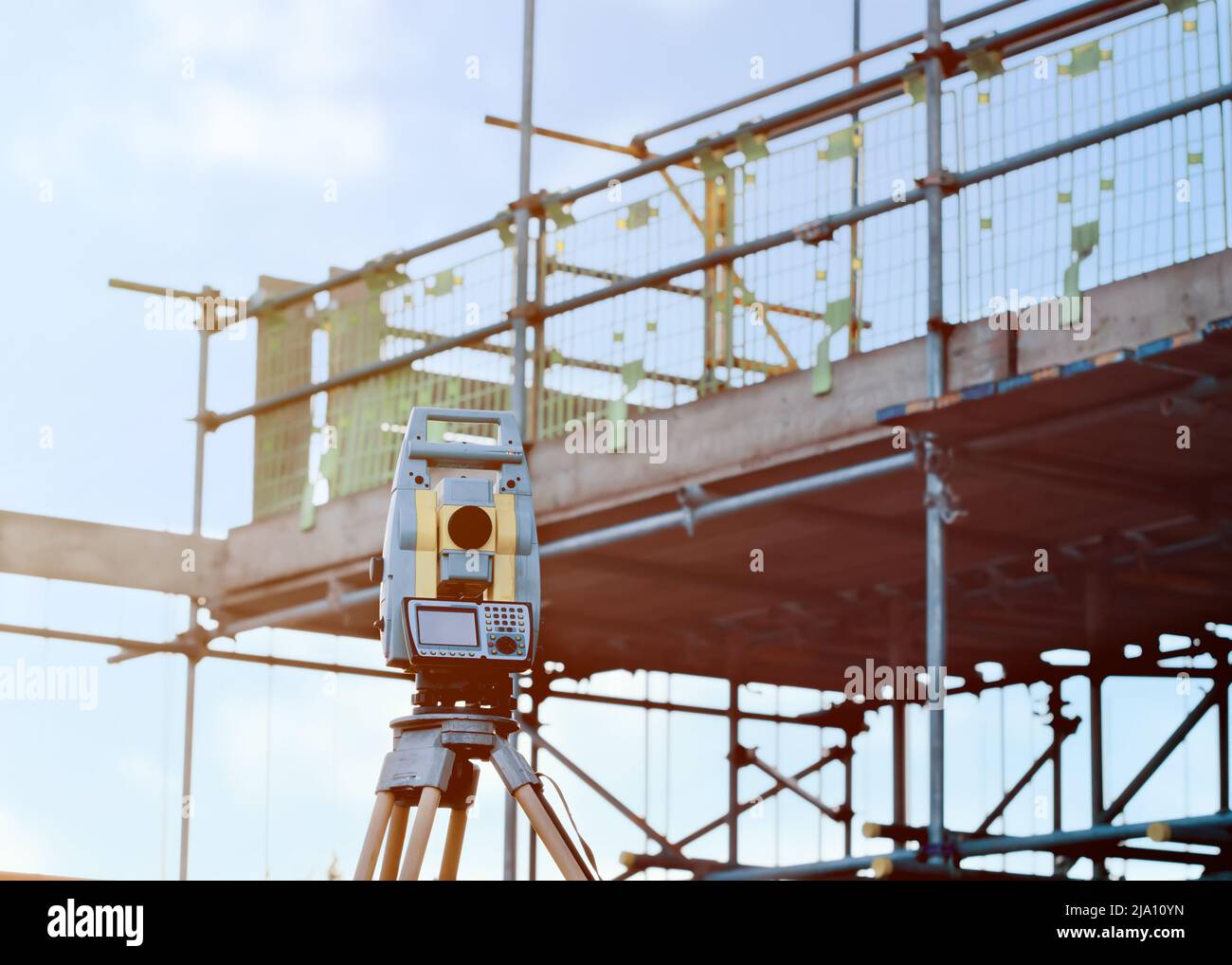 Total station set by engineer on construction site in front of ...