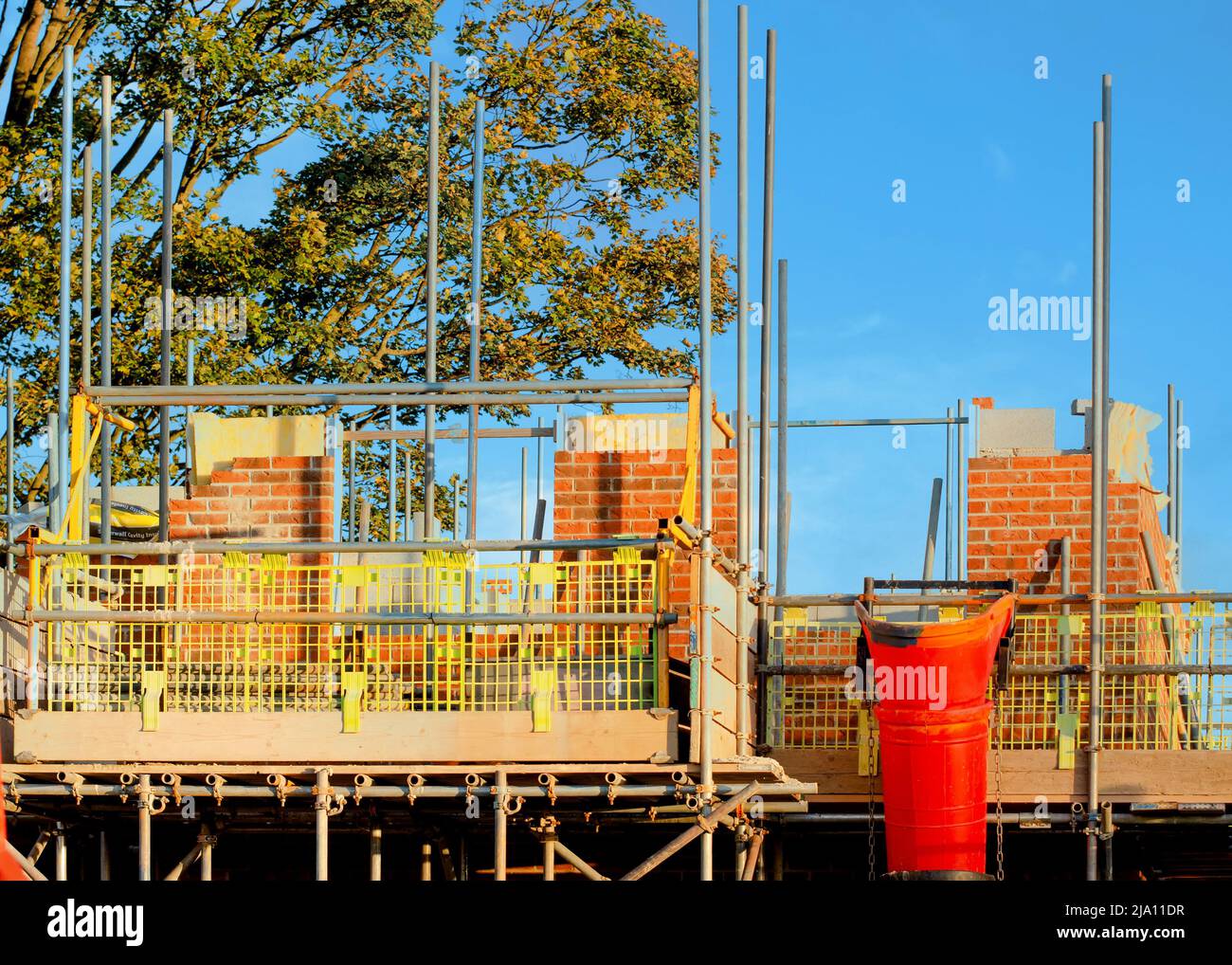 New residential house under construction and scaffolds erected around ...