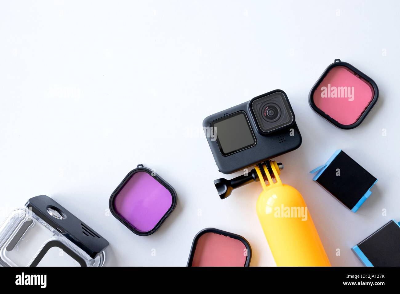 The all new black action camera and diving accessories on white table ...