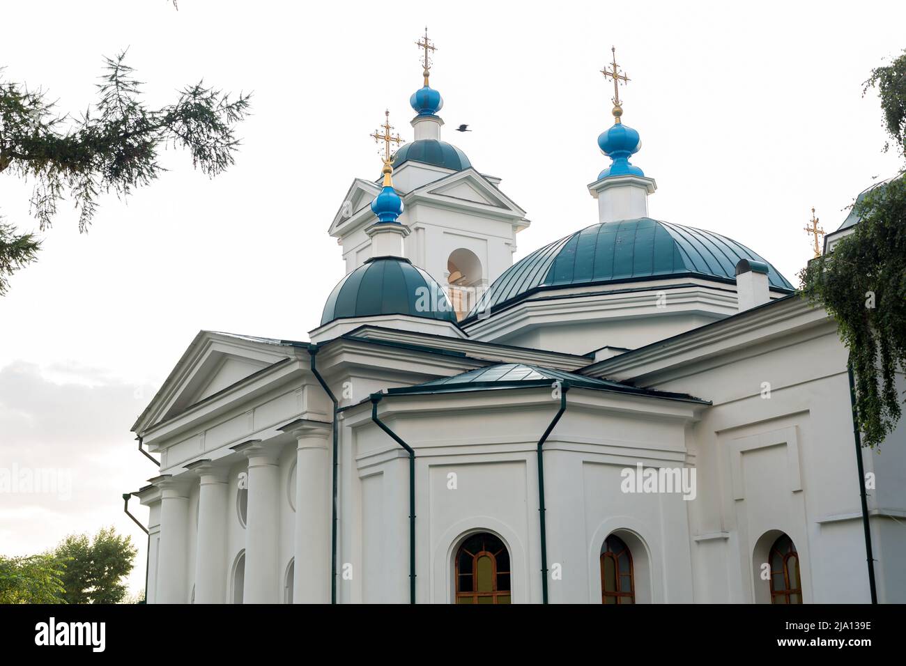 A large white church with blue domes and golden crosses Stock Photo - Alamy