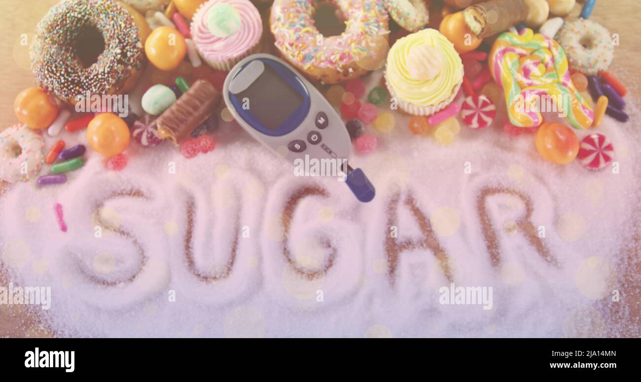 Image of sugar text over glucose meter and sweets Stock Photo - Alamy