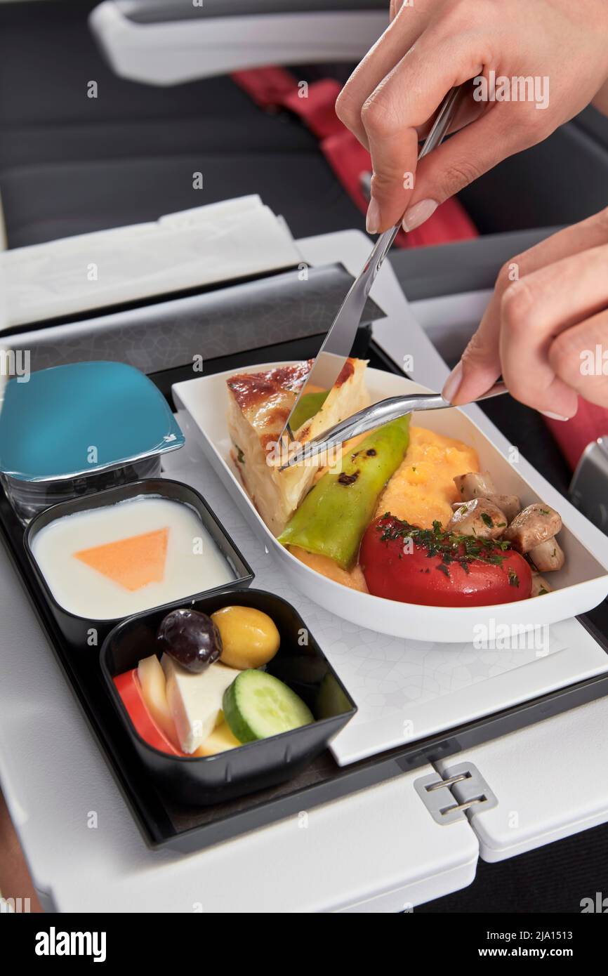 Plane passenger eating hi-res stock photography and images - Alamy
