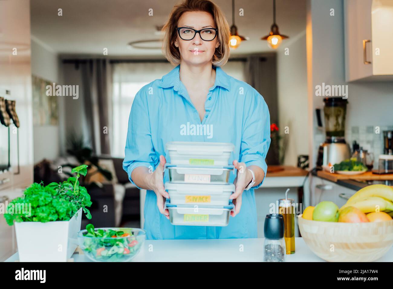 Healthy diet plan for weight loss, daily ready meal menu. Woman holding ...