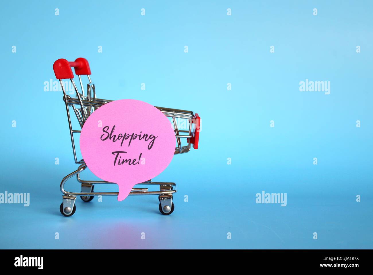 Shopping trolley and speech bubble with text SHOPPING TIME! on blue ...