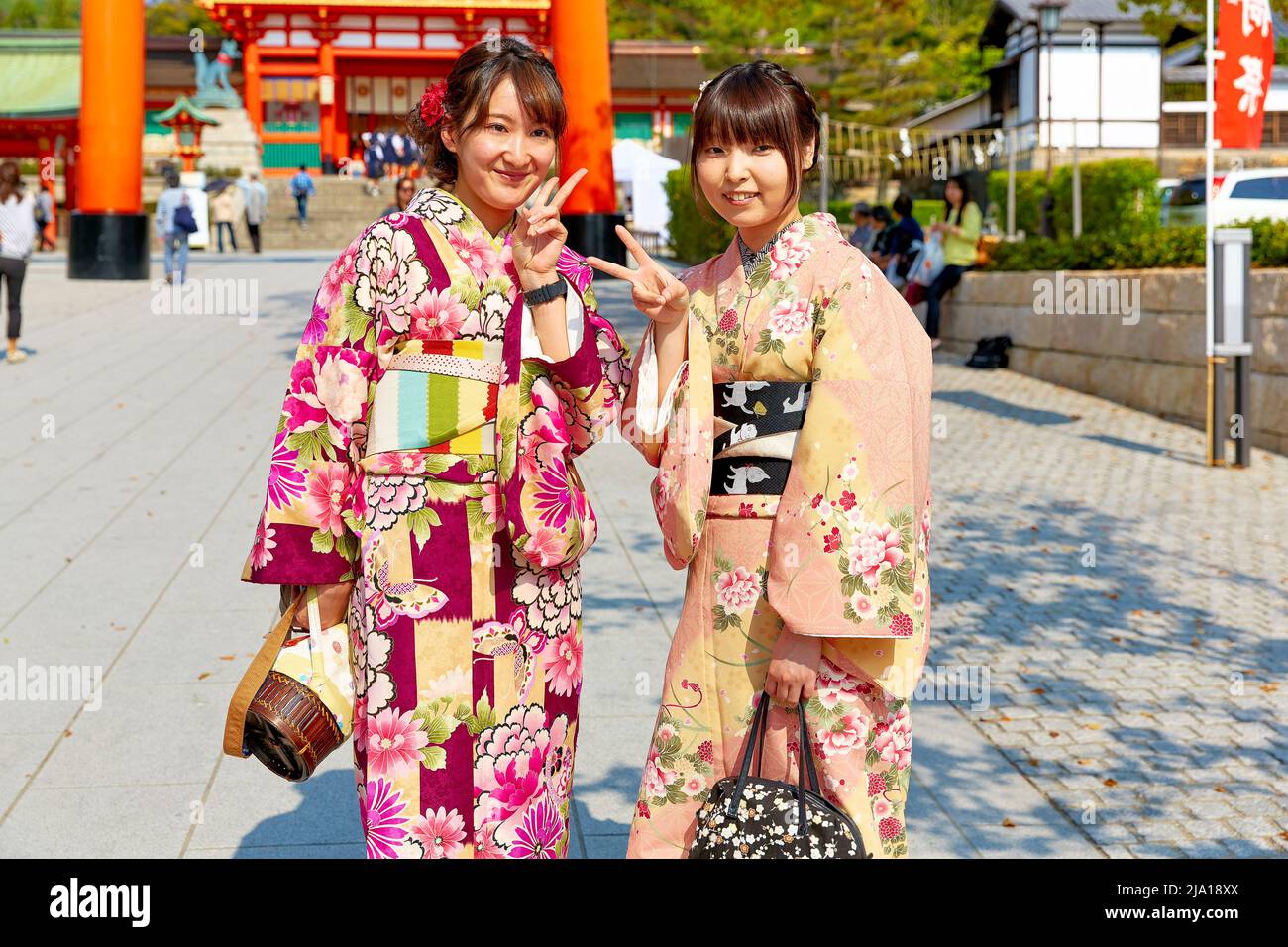Japan. Kyoto. Fushimi Inari Taisha Shrine. Young smiling women dressed ...