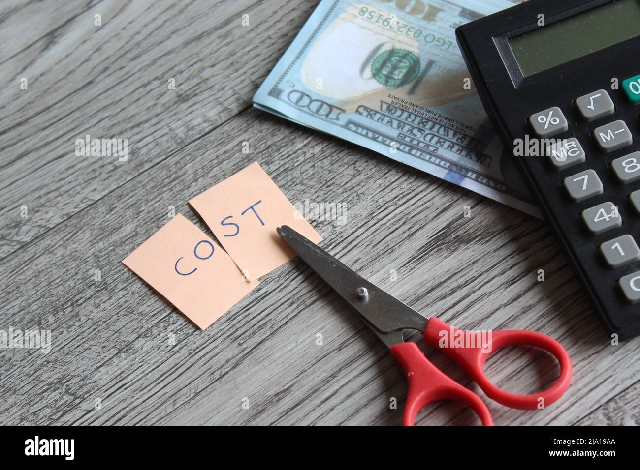 Scissor, calculator, money and note with text COST. Financial, cost ...