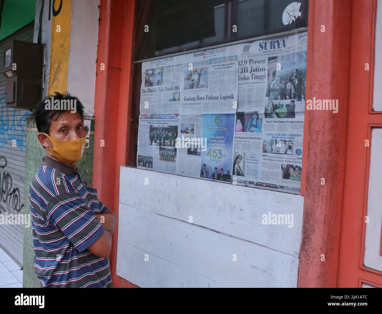 Malang, East Java, Indonesia. 26th May, 2022. A man reads a newspaper ...