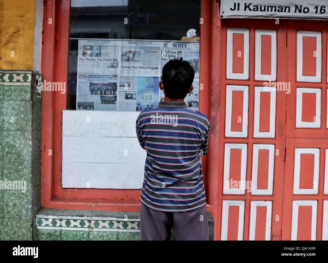 Malang, East Java, Indonesia. 26th May, 2022. A man reads a newspaper ...