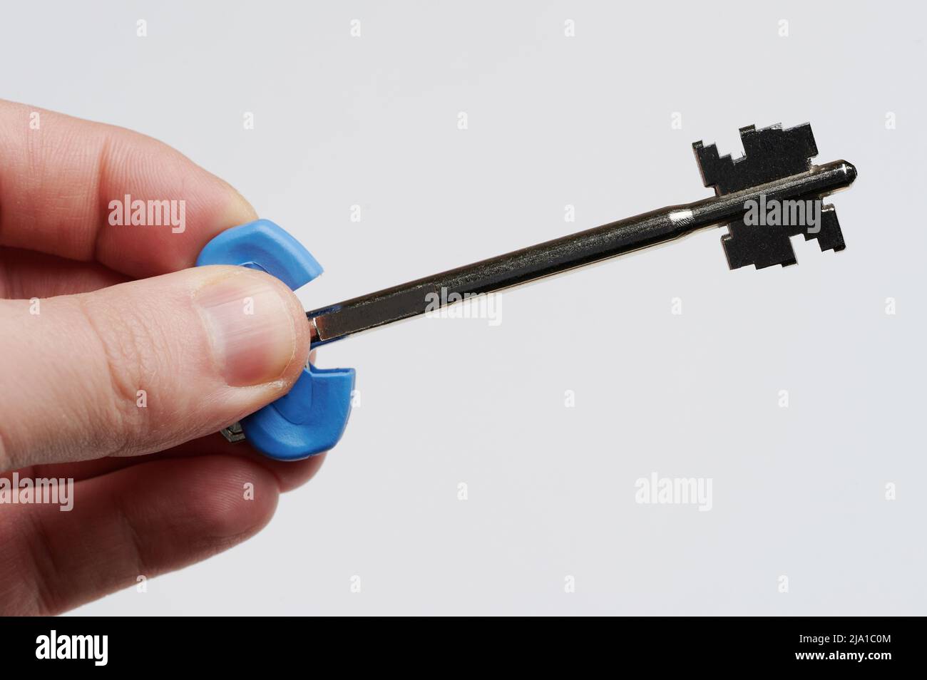 New metal key for house door in human hand isolated Stock Photo - Alamy