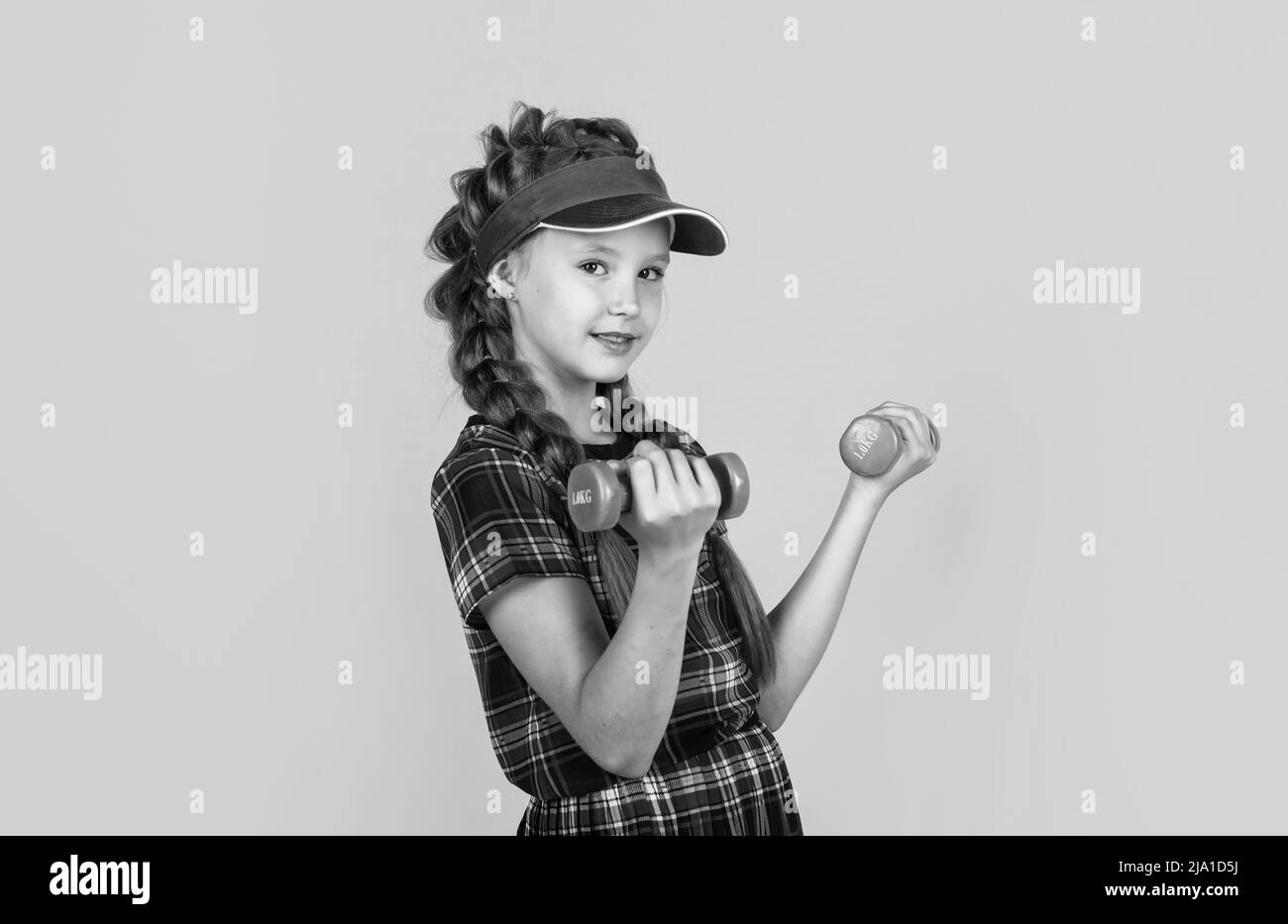 healthy sporty tween girl hold barbells, workout Stock Photo - Alamy