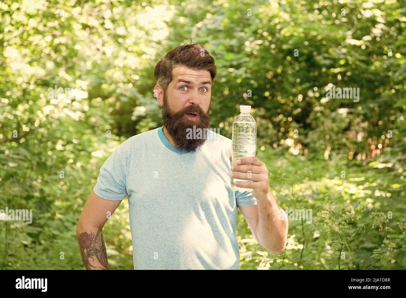jogging drinking water. guy maintains body water balance. hydration ...