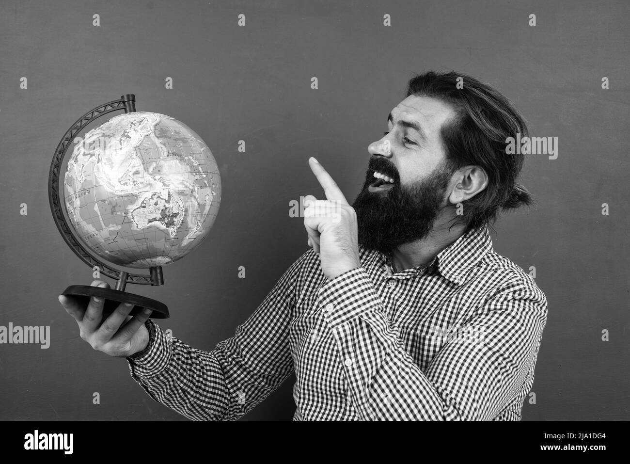 Man planning vacation looking at geographic globe in school, trip Stock ...