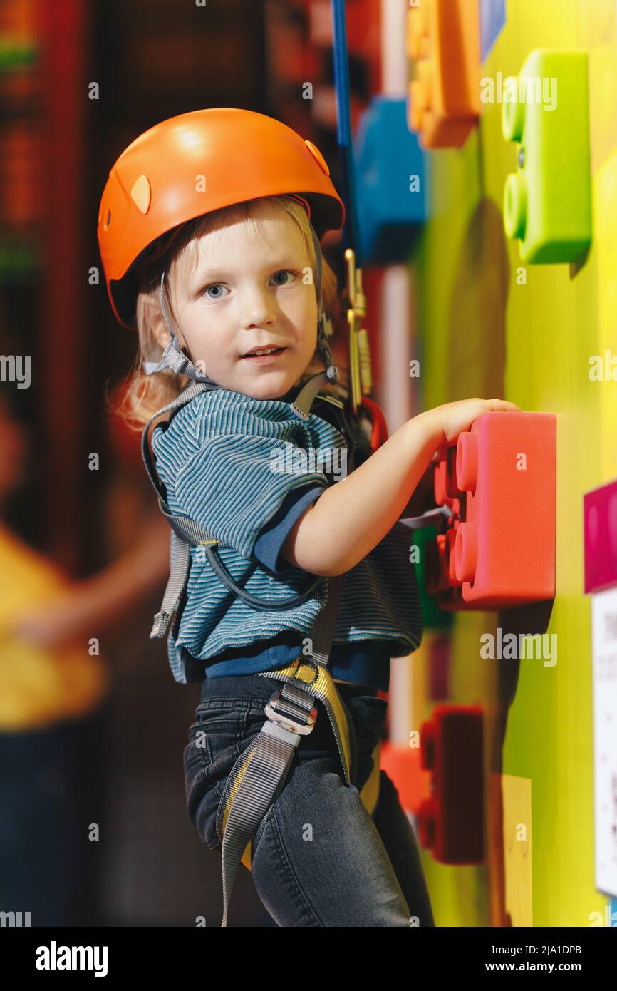 Happy School Boy in Red Helmet on Climbing Class at Indoor Climbing and ...