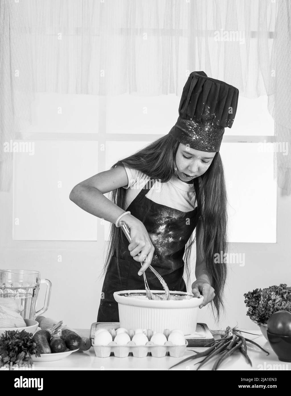 teen girl in cook uniform prepare food in kitchen, cooking Stock Photo ...