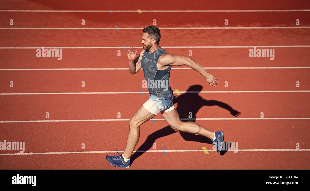 marathon speed. sprinter. energetic man on running track. sporty runner ...