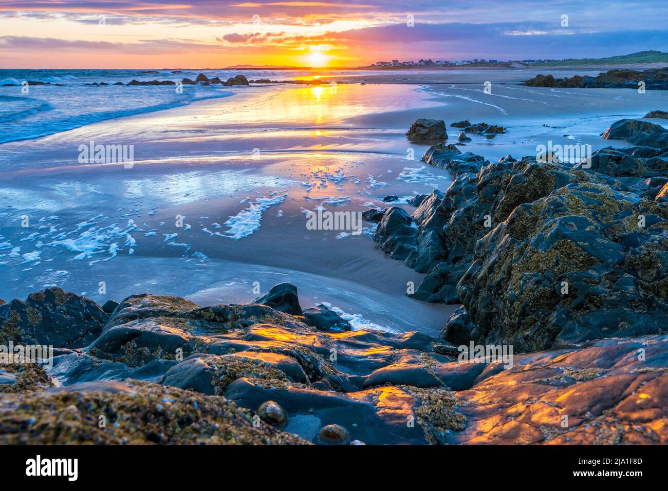 The sunset at Rhosneigr on Anglesey, Wales Stock Photo - Alamy