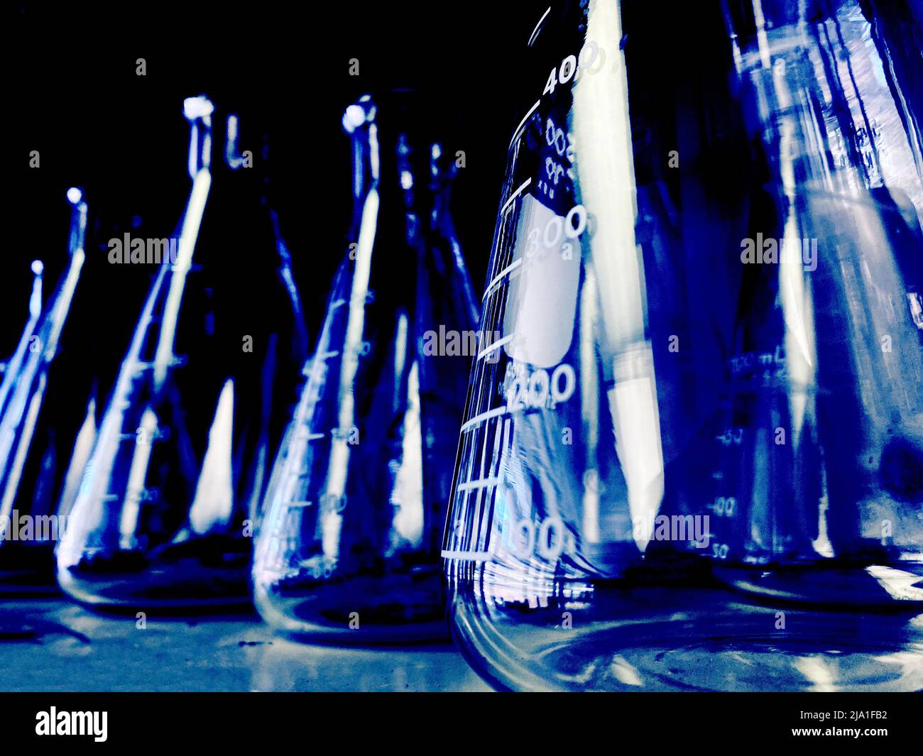 Laboratory glassware on a shelf. Erlenmeyer flasks in a lab Stock Photo ...