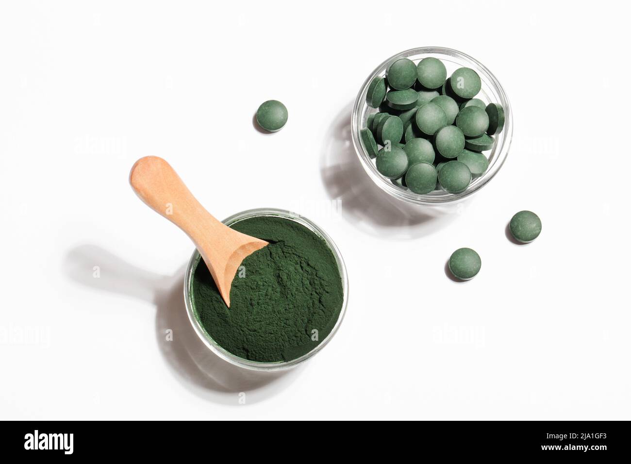 natural additives and superfood. green spirulina algae powder and pills ...