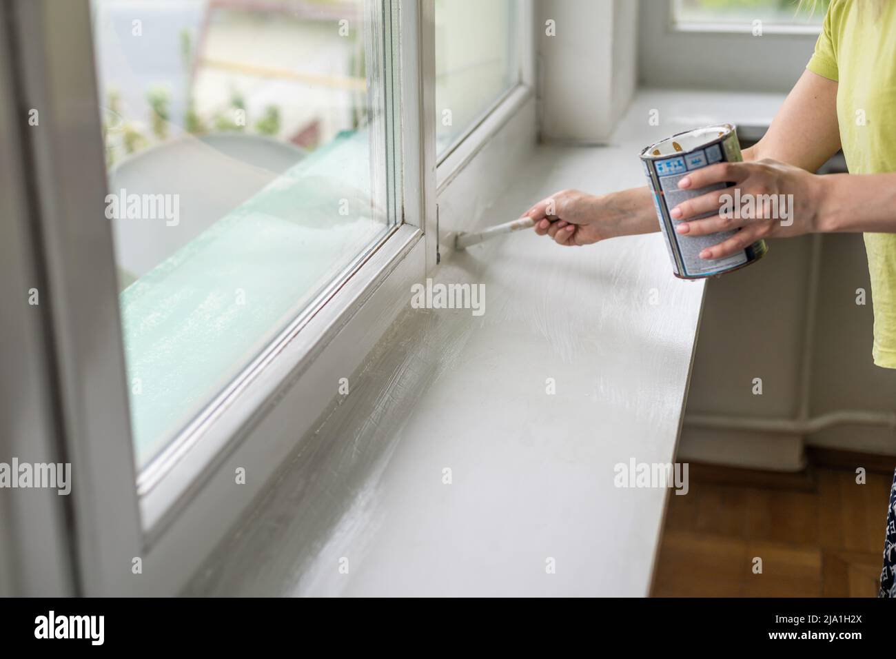 painting a window frame with white color Stock Photo - Alamy