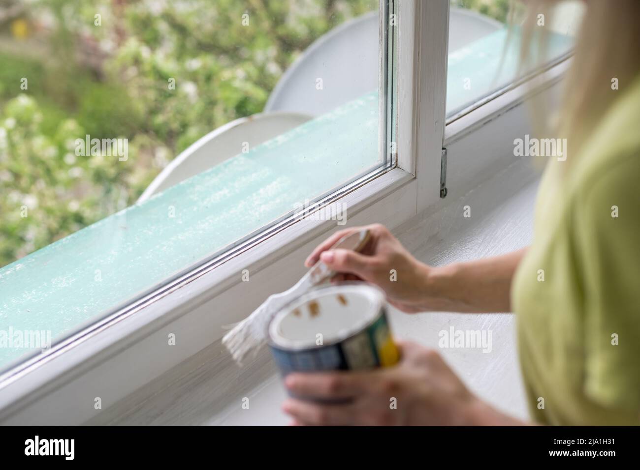 hand painting the window frame Stock Photo - Alamy